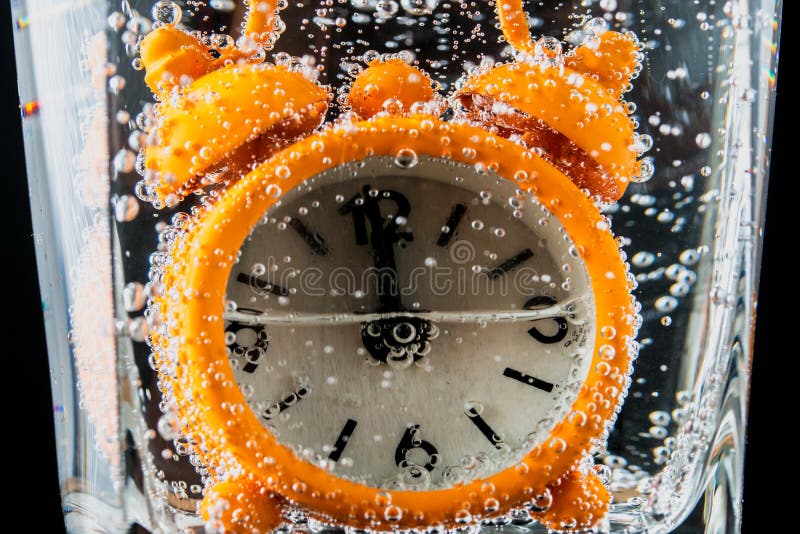 Alarm clock in a glass stock image. Image of clock, color - 62456945