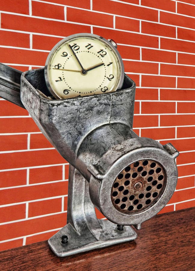 Alarm Clock in Meat Grinder on Red Brick Wall Background. Stock Photo ...