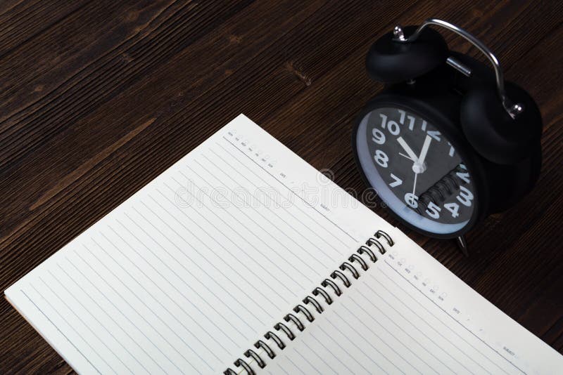 Alarm Clock and Notebook with Pen on Dark Wooden Floor, Empty Sp Stock ...