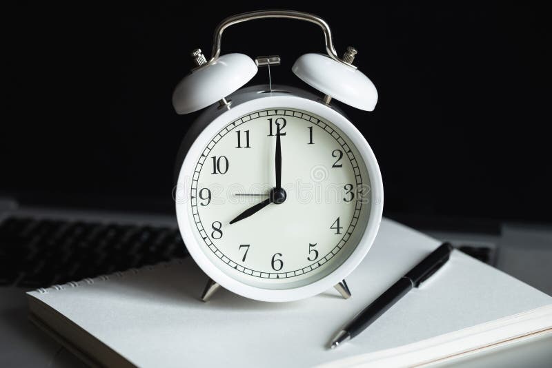 Alarm Clock, Notepad and Laptop at the Workplace, Close-up. Stock ...