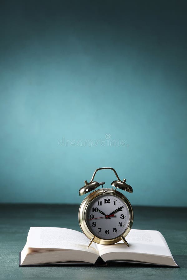 Alarm clock on open book stock image. Image of ideas - 26105689