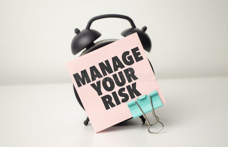 Alarm Clock with Pink Sticker with the Text Manage Your Risk Stock ...