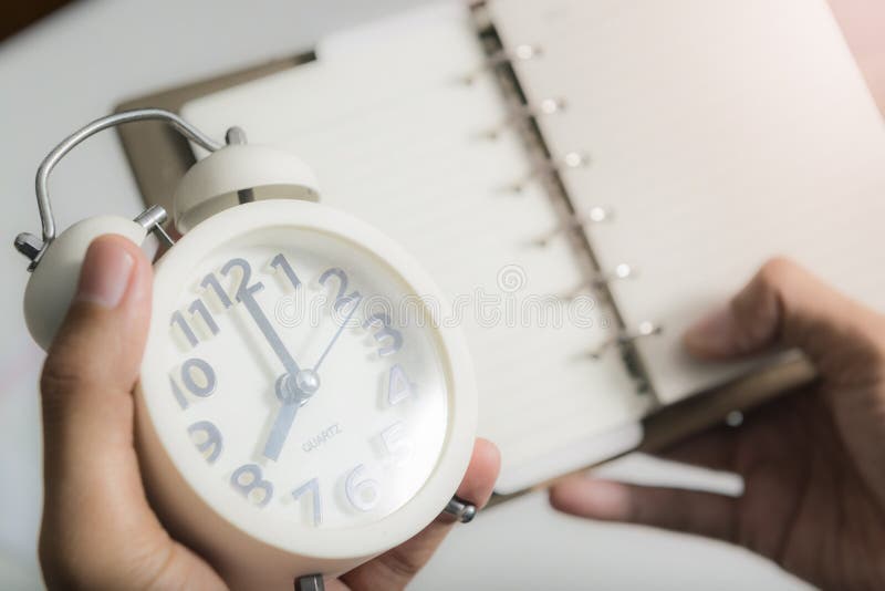 Clock on a Planner on a Wooden Table - Time Management Concept Stock ...