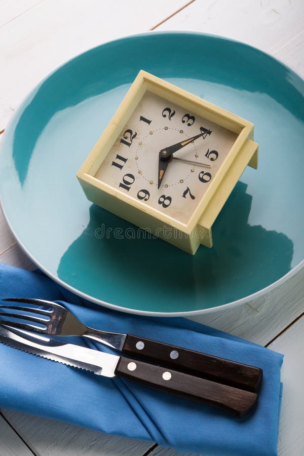 Alarm clock on a a plate stock photo. Image of breakfast - 139464486