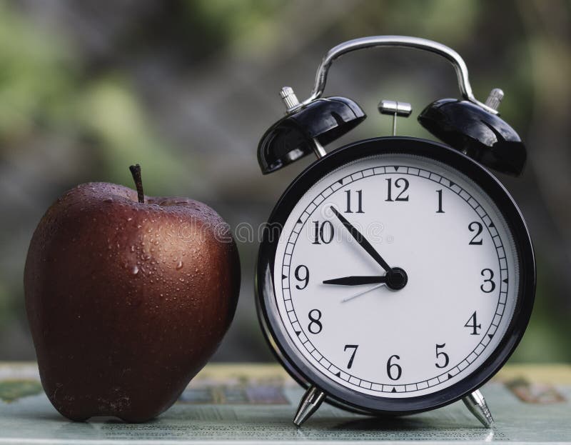 Alarm Clock and Red Apple on Books Stock Image - Image of morning ...