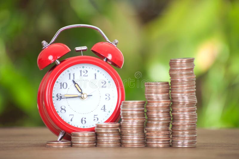 An Alarm Clock and a Row of Increasing Dollar Coins Stock Photo - Image ...
