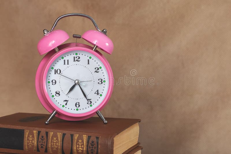 Alarm Clock on a Stack of Books. Clock in the Library Stock Image ... Alarm Clock on a Stack of Books. Clock in the Library Stock Image ...