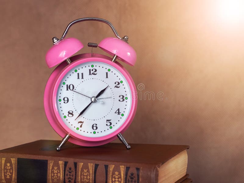Alarm Clock on a Stack of Books in the Library Stock Photo - Image of ...