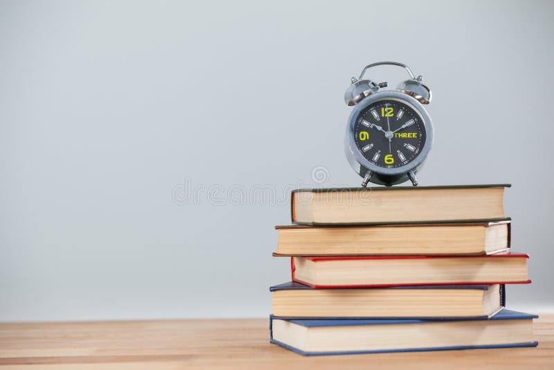 Alarm Clock and Stack of Books Stock Photo - Image of reading, bell ...