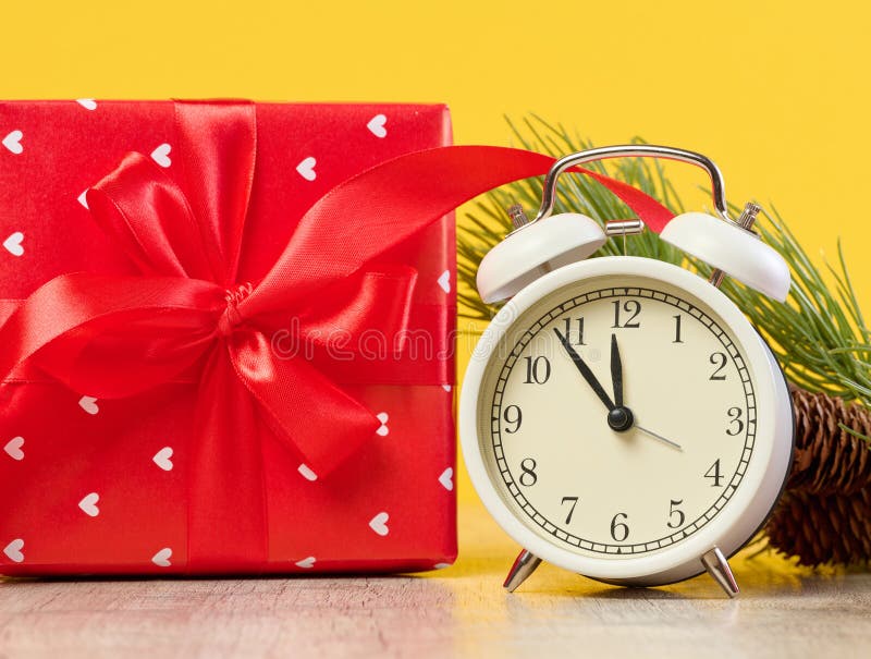 Alarm Clock and Stack of Red Gift Boxes on Yellow Background Stock ...