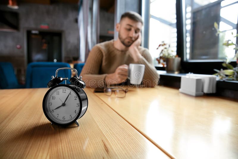 Alarm Clock on Table of Bored Young Man in Cafe Stock Photo - Image of ...