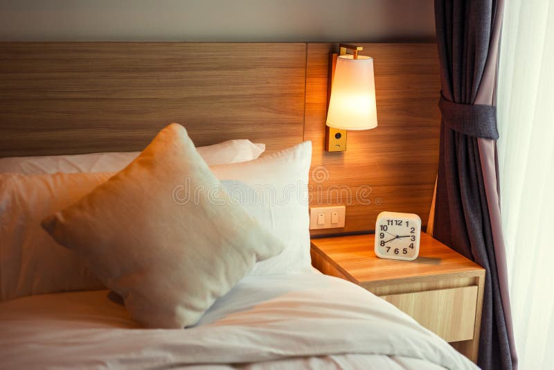 Alarm Clock on the Table Under the Lamp Near Bed Stock Image - Image of ...