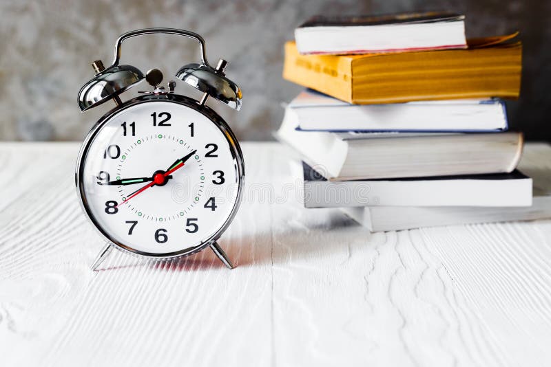 Alarm Clock Time To Read Books Stock Photo - Image of time, table: 77920236
