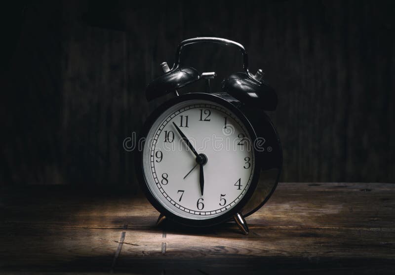Alarm Clock on a Wooden Table at Night Stock Photo - Image of clock ...