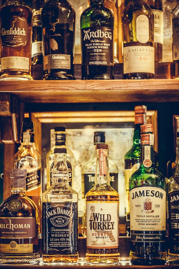 Alcohol bottles in a bar editorial stock photo. Image of alignment ...