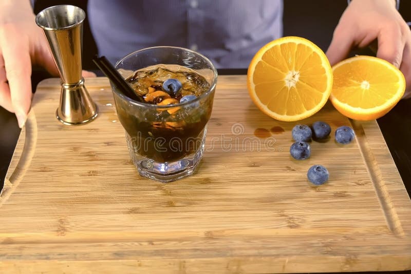 Alcohol Cocktail on the Rocks Glass with Orange, Ice and Blueberry on ...
