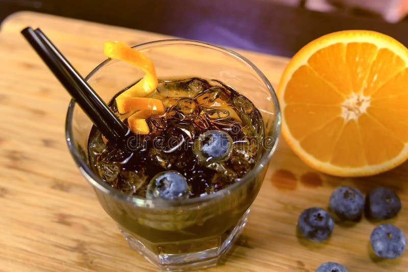 Alcohol Cocktail on the Rocks Glass with Orange, Ice and Blueberry on ...