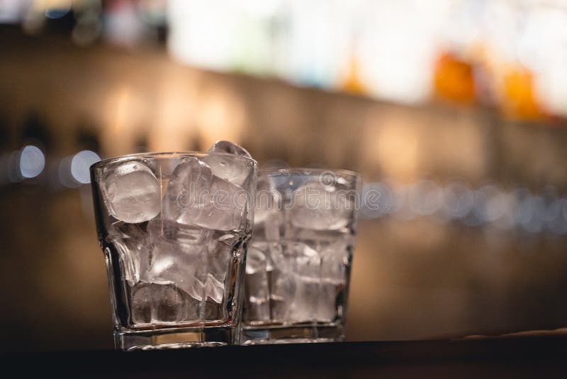 An Alcoholic Drink with Ice is Served by the Bartender at the Bar Stock ...