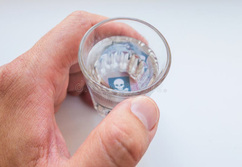 The Alcoholic Holds a Glass of Vodka with a Skull and Bones. Stock ...