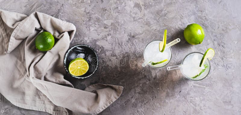 Alcoholic Mojito Cocktail with Lime and Ice in Glasses on the Table Top ...