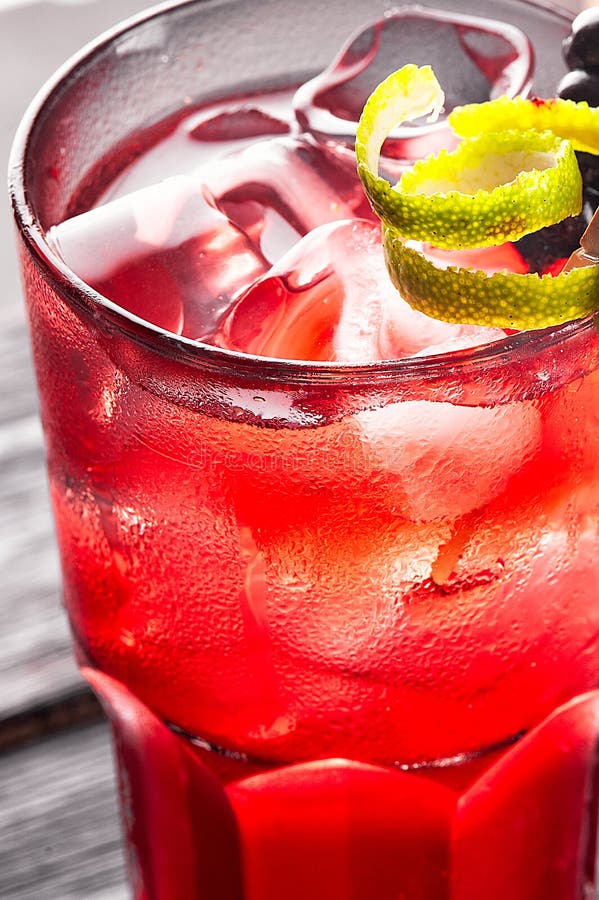 Alcoholic, Non-alcoholic Red Cocktail with Ice on Black Wooden Table ...