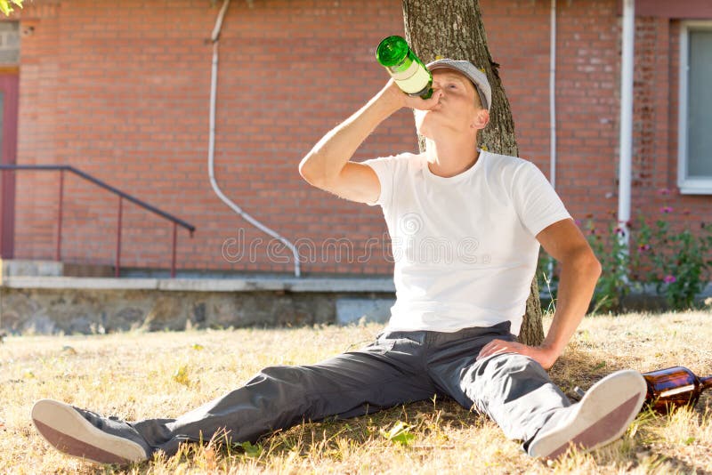 Alcoholic Sitting Drinking Under a Tree Stock Image - Image of ...