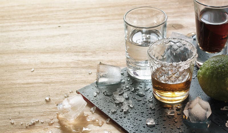 Alcoholic Strong Drinks on the Background and Pieces of Lime Stock ...