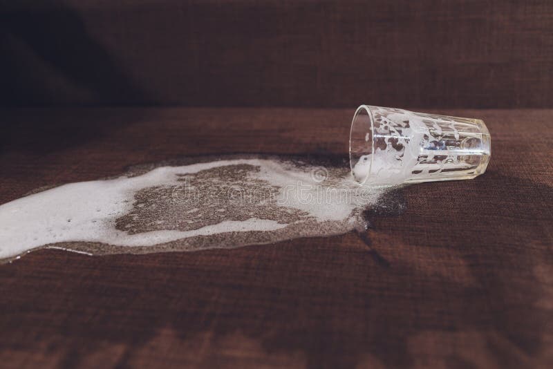 Alcoholism in the Family. Beer Bottle and Spilled Beer in the Sofa ...