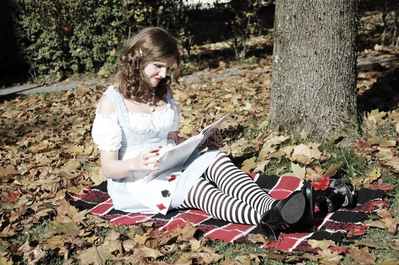 Alice reading a book stock image. Image of wonderland - 24655431