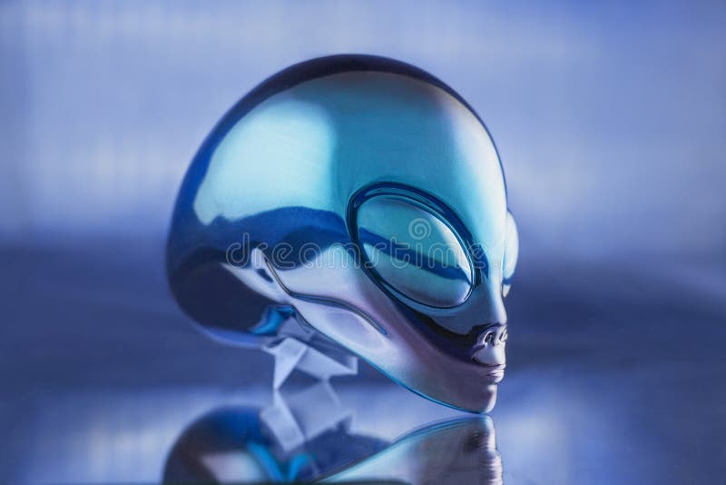 Alien Metal Head Statue on Blue Background on the Table Stock Image ...