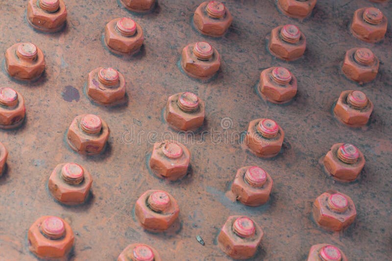 Aligned red nuts and bolts stock photo. Image of bolts - 44387616
