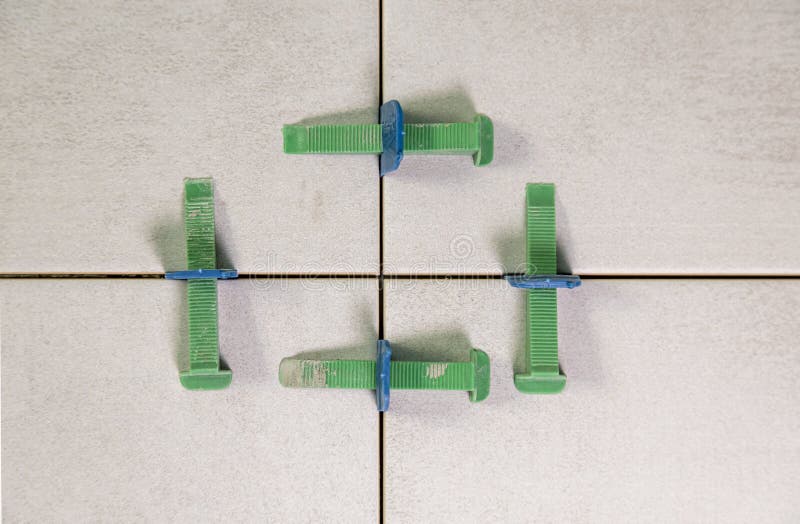 Aligning Ceramic Tiles on the Wall in the Bathroom. Self-leveling ...