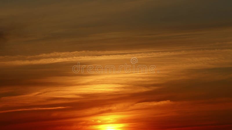 All the Colors of Sunset on a Layered Cloudy Sky. the Sun is Touching ...