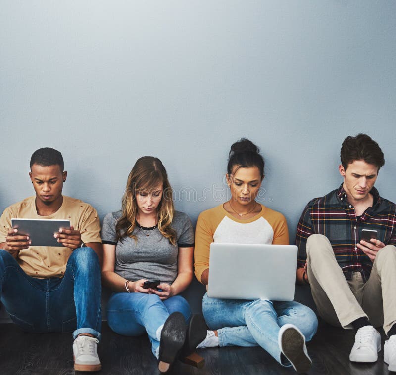 We All Have a Device of Choice. Studio Shot of a Group of Young People ...
