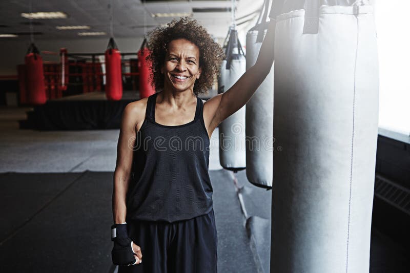 We All Have a Fighter in Us. a Female Kick-boxer Training at the Gym ...