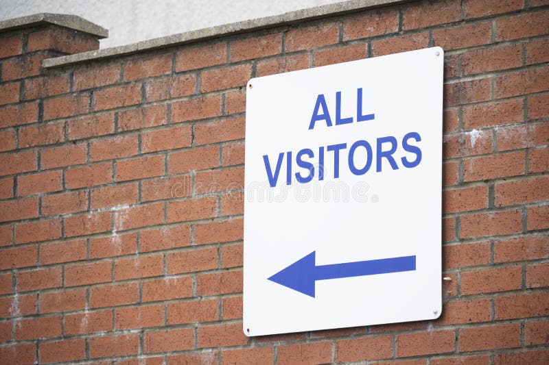All Visitors Arrow Direction Sign on Wall of Car Park Stock Photo ...