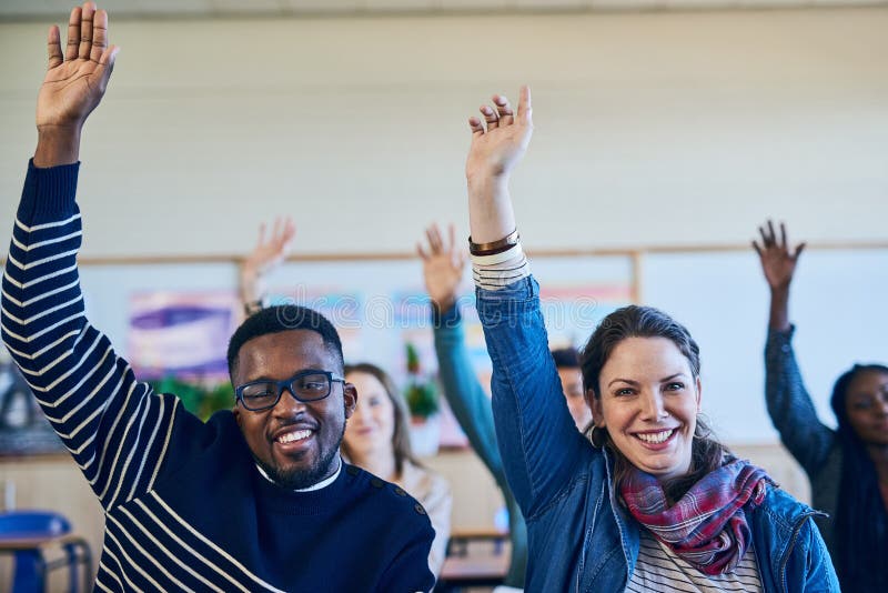 We All Want More in Life. a Group of Students Raising Their Hands in ...