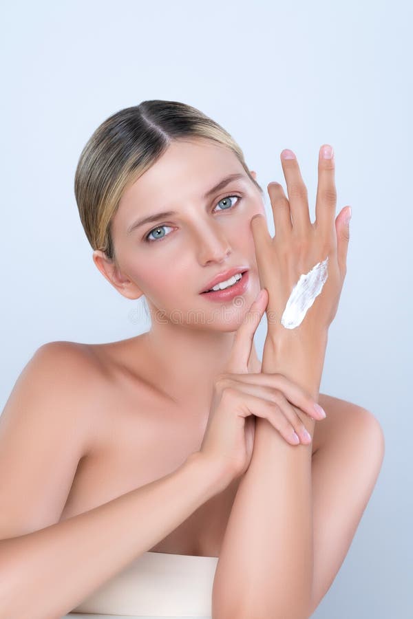 Alluring Beautiful Woman Applying Moisturizer Cream On Her Hand For
