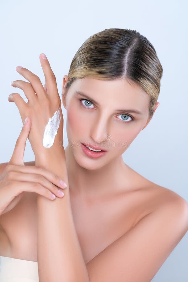 Alluring Beautiful Woman Applying Moisturizer Cream On Her Hand For