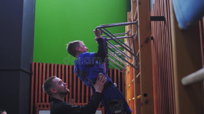 Coach Helps Student Do Pull-up on Horizontal Bar in Gym Stock Video ...