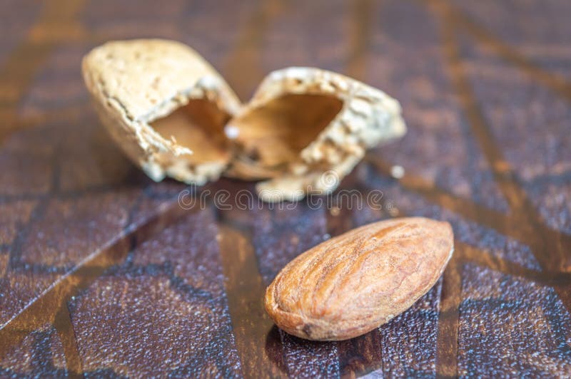 Almond Fruit Broken from the Brown Almond Shell on a Brown Wooden ...