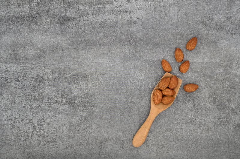Almond in Spoon and Group of Almond Nuts on Stone Texture Background ...