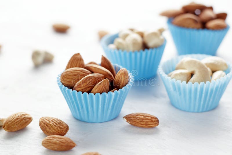 Almonds in the Blue Paper Baking Molds on White Table. Stock Photo ...