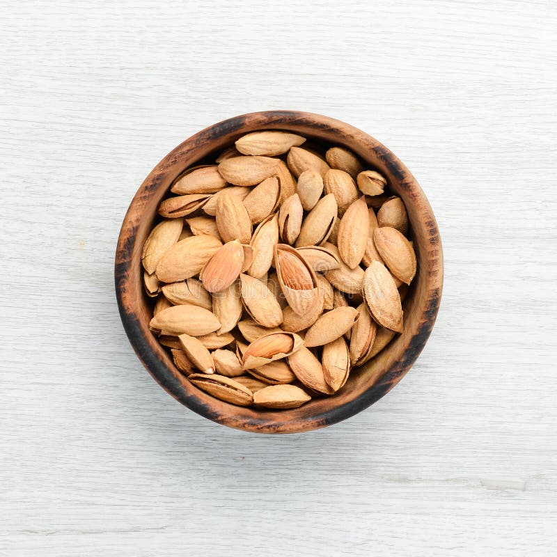 Almonds in Bowl on White Wooden Table. Top View Stock Photo - Image of ...
