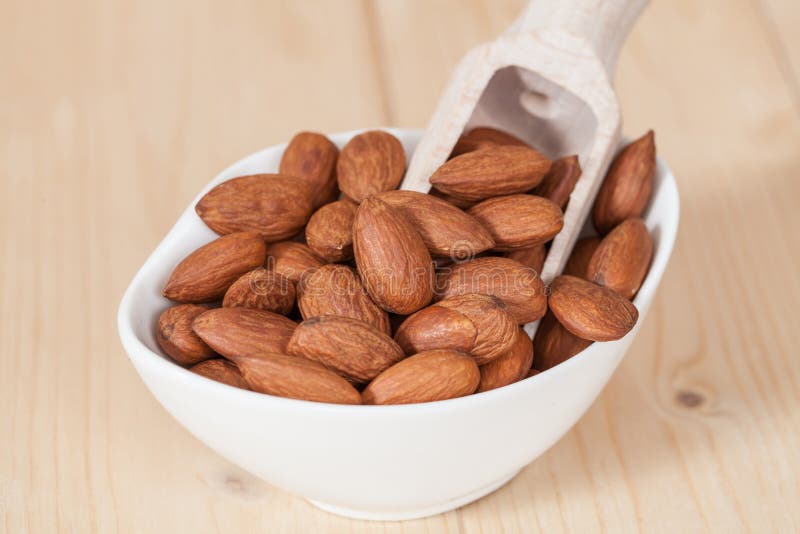 Almonds in bowl on wood stock image. Image of protein - 67630013