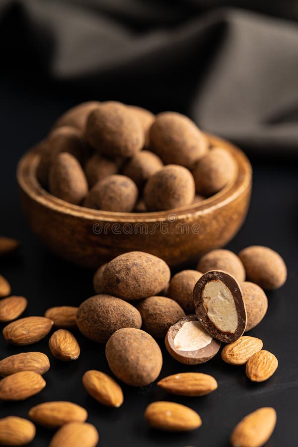 Almonds in Chocolate Coated in Cocoa in Bowl on Dark Table Stock Photo ...