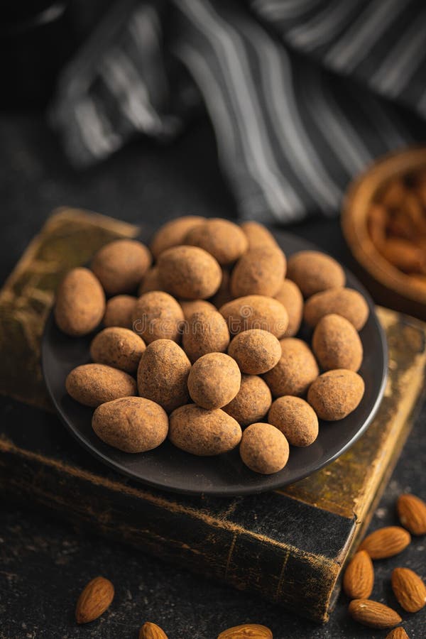Almonds in Chocolate Coated in Cocoa on Plate Stock Photo - Image of ...