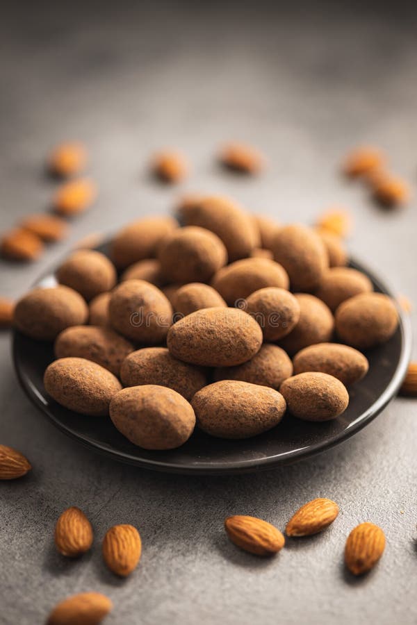 Almonds in Chocolate Coated in Cocoa on Plate Stock Photo - Image of ...