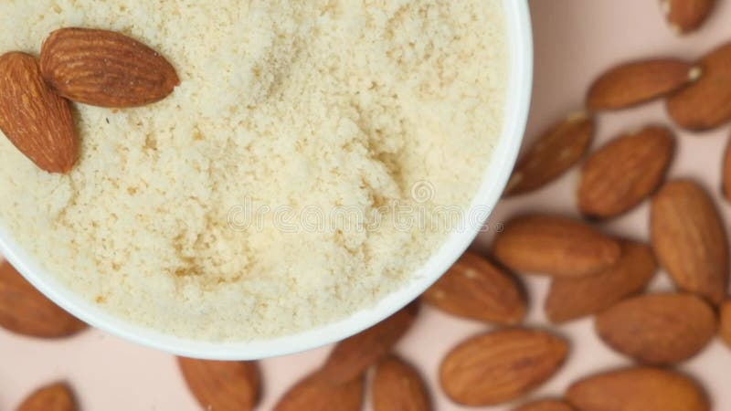 Almonds Falling in Almond Flour Top View Macro Slow Motion. Stock ...