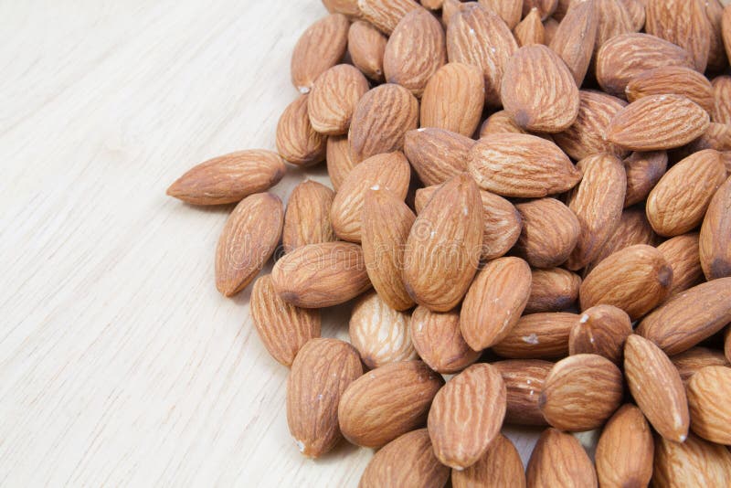 Almonds on grained wood stock image. Image of edible - 75318379
